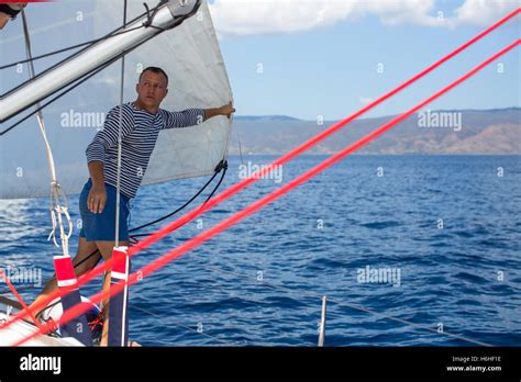 Young Man Skipper Setting Sails On The Sailing Yacht Boat Vacation Holidays Travel Stock