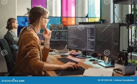 Professional Female Backend Software Developer Coding On Desktop Computer With Two Displays In