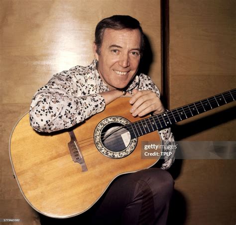 Irish Singer Val Doonican Poses For A Portrait With His Guitar In