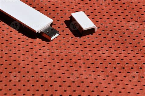 A Modern Portable Usb Wi Fi Adapter Is Placed On The Red Sportswear