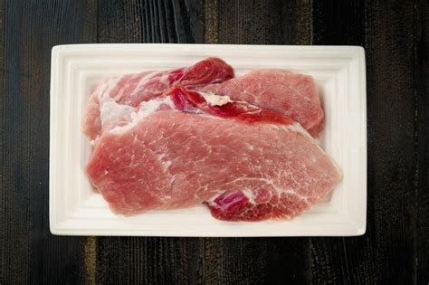 Premium Photo Fresh Pork Chop Meat On A Dark Background