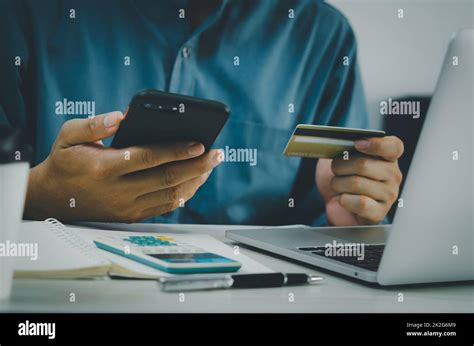 Man Hand Holding Credit Card And Mobile Phone Online Shopping E