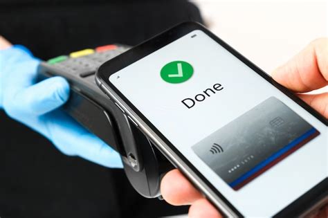 Premium Photo Close Up Of Woman Hand In Rubber Gloves Holding A Pos Terminal Or Swiping