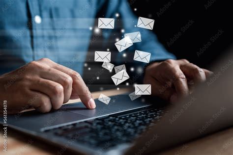 businessman sending email by laptop computer to customer business contact and communication