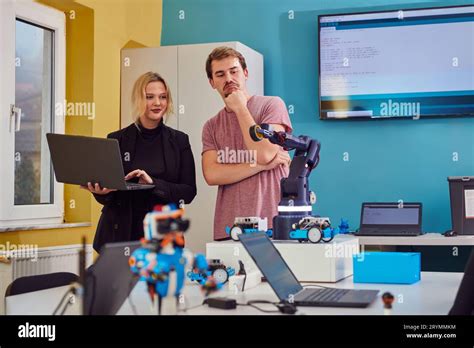 A Group Of Colleagues Working Together In A Robotics Laboratory