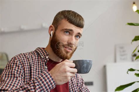 快乐的年轻迷人的姜黄色胡须男子手持灰色咖啡杯的肖像高清图片下载 正版图片504227753 摄图网