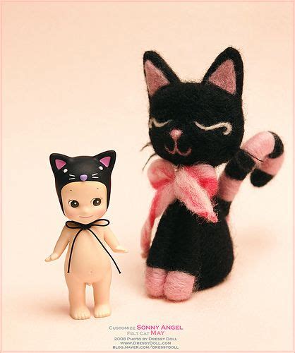Two Toy Cats Are Standing Next To Each Other On A Pink Background With The Caption Sorry Angel