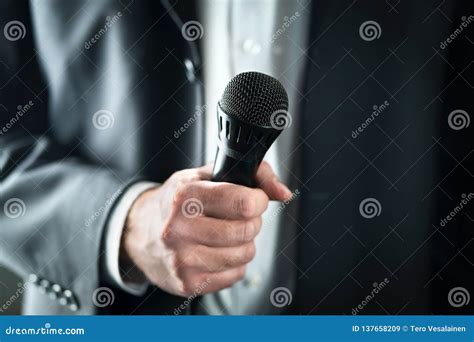 Business Man Holding Microphone Public Speaking And Giving Speech In Suit For Audience Concept