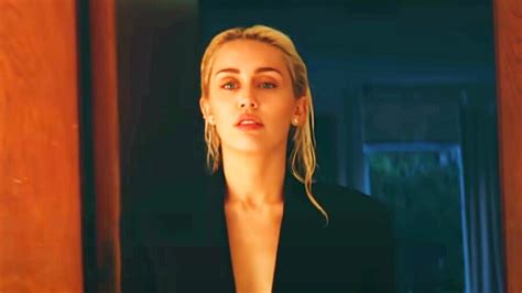 See Miley Cyrus Dramatically Pose In A Black Swimsuit GIANT FREAKIN ROBOT