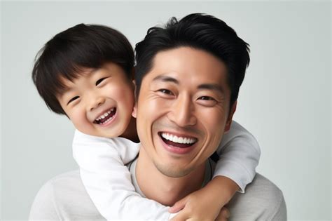 Premium Photo Portrait Of A Happy Asian Father And Son Isolated On