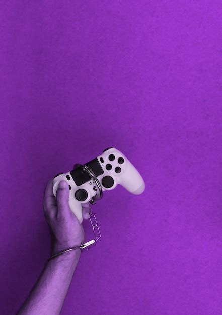 Premium Photo Video Game Joystick And Handcuffs Isolated Addiction To
