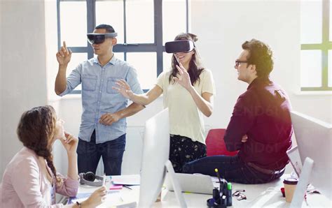 Computer Programmers Testing Virtual Reality Simulator Glasses In