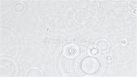 Slow Motion Rain Drops And Ripples On Water Surface On White Abstract Background Stock Footage
