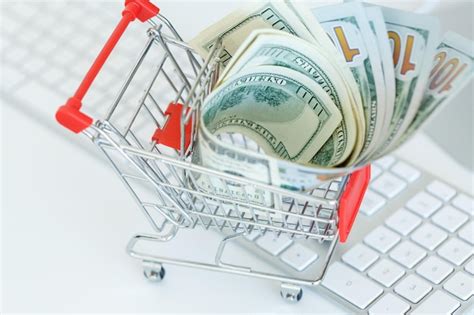 Premium Photo Dollars In The Shopping Cart On A Computer Keyboard