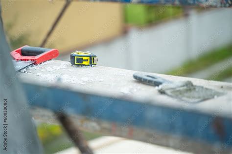 Construction Tape Measure And Spatula On Scaffolding On A Blurred Background Styrofoam Gluing