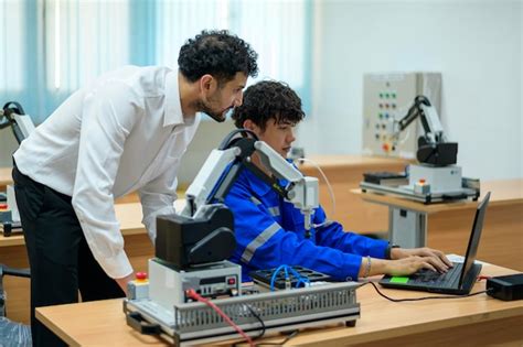 Premium Photo Trainee Robotics Engineer Learning With Programming And Manipulating Robot Hand