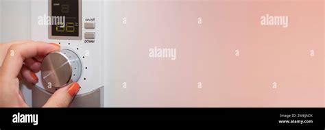 Gas Boiler A Woman Regulates The Temperature With A Temperature Controller Setting The Room