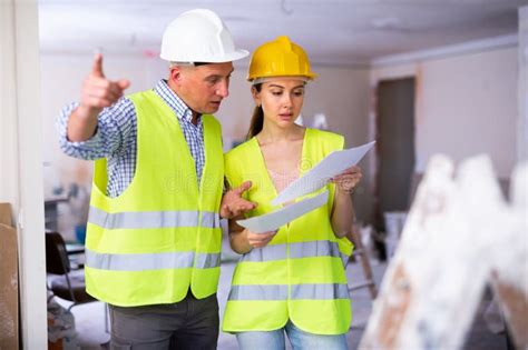 Woman Architect And Man Engineer Discussing Work Plan In Apartment