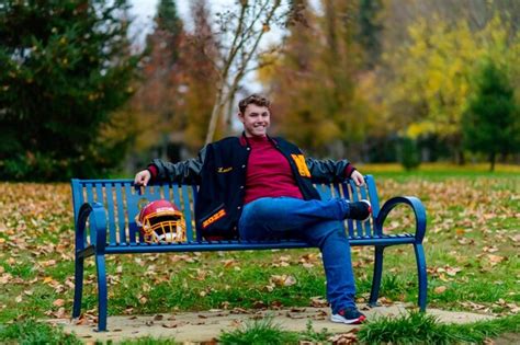 Premium Photo Portrait Of Man Sitting On Park Bench