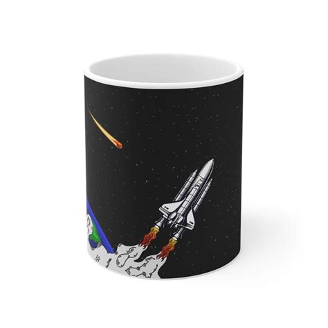 A Coffee Mug With An Image Of A Space Shuttle In The Sky And Stars On It