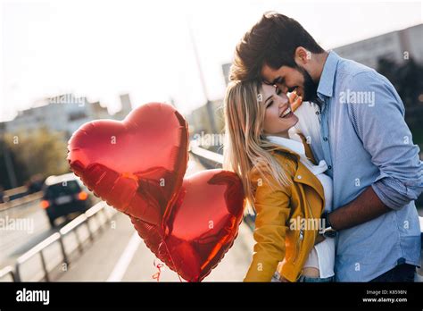 Couple In Love Cuddling While Enjoying Beautiful Urban Sunset Together