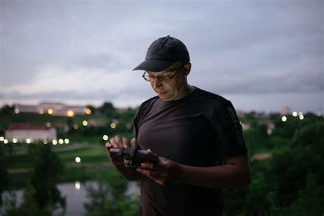 Premium Photo Man Operating A Drone Using A Remote Controller Man