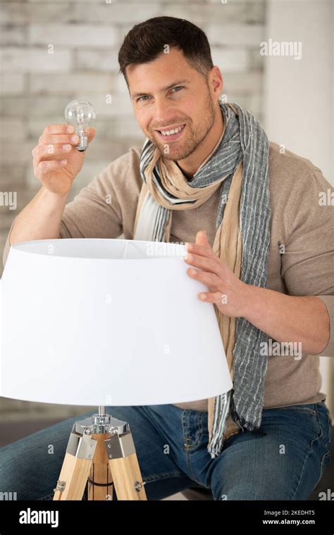 Asian Man Changing Light Bulb Stock Photo Alamy