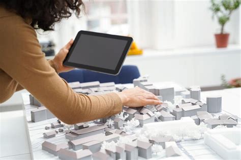 Premium Photo Woman Architect Using Tablet At Library Table While Creating City Workout