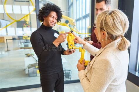 Engineers Discussing Robotics Design In A Modern Industrial Workspace