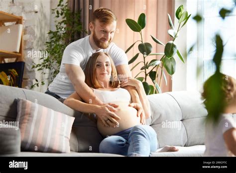 Support And Care Loving Man Husband Holding Hand On His Wife Belly Couple Spending Time At