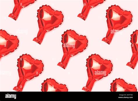Repetitive Pattern Made From Red Heart Foil Balloon Creative Layout On A Pink Background Stock