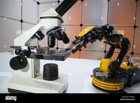 Microscope Slide In Robot Arm And Science Microscope Stock Photo Alamy