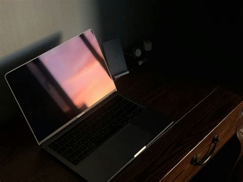A Laptop Computer Sitting On Top Of A Wooden Desk Photo Free Computer