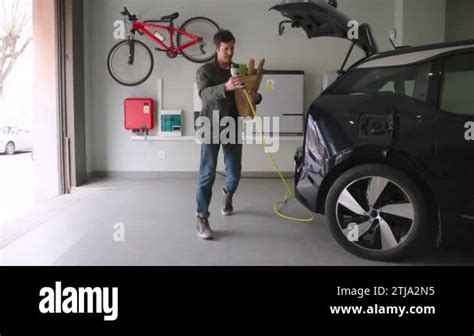 man multitasking arrives home after shopping at the grocery store and