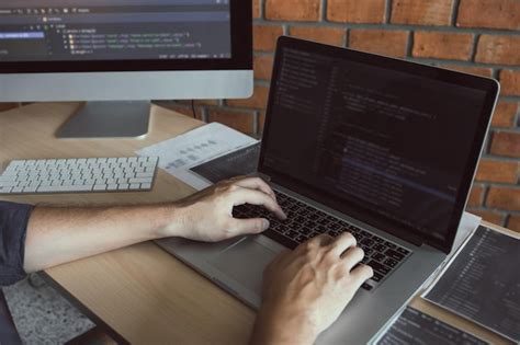 Premium Photo Cropped Hand Of Computer Programmer Working In Office