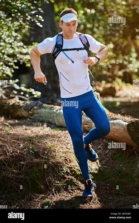 He Loves A Good Trail Run A Young Man Running Along A Nature Trail