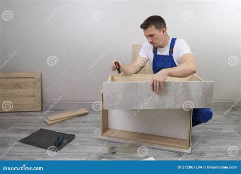 Professional Furniture Assembler Installs Door Opening And Closing