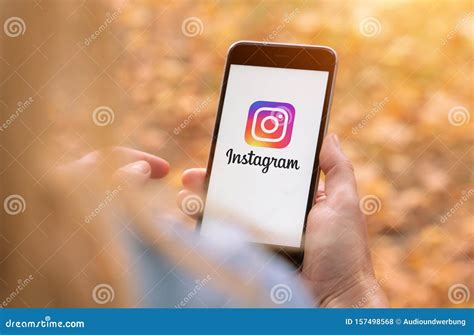 Woman Holding A Apple Iphone Opening Instagram App Instagram Is A