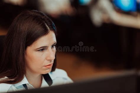 female security operator working in a data system control room offices