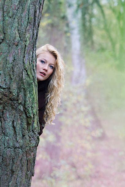 Woman Hiding Behind Tree