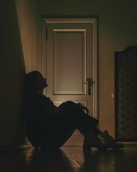 A Person Sitting Alone In A Dimly Lit Room Photos Download The Best