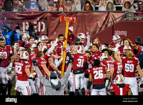 Wisconsin Celebrates With The Paul Bunyan Axe Trophy After Beating
