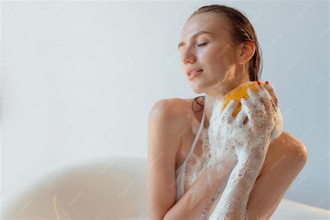 Girl Washes Her Body With Shower Gel And Shampoo With Foam Closeup