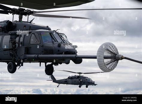 An Hh 60g Pave Hawk Helicopter Receives Fuel From An Hc 130j Combat