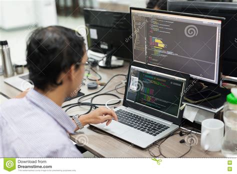 asian outsource software developer looking screen sitting at desk stock image image of coding