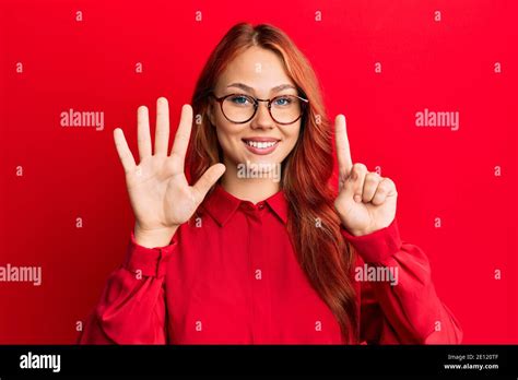 Young Beautiful Redhead Woman Wearing Casual Clothes And Glasses Over