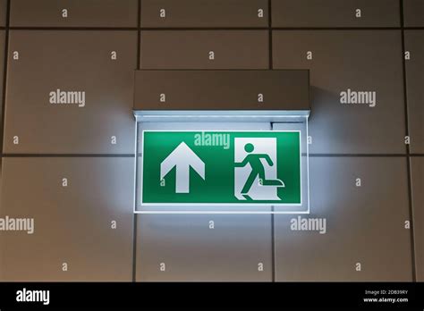 Emergency Exit Sign Glowing In The Dark Stock Photo Alamy