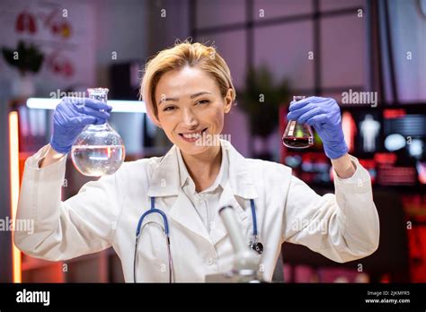 Positive Female Scientist Or Medical In Lab Coat Holding Test Tube With