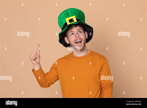Attractive Young Guy With A Big Green Hat On A Yellow Background Stock
