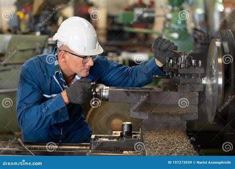 Male Worker Working On A Lathe Machine In Metal Industry Factory On A Business Day Stock Image